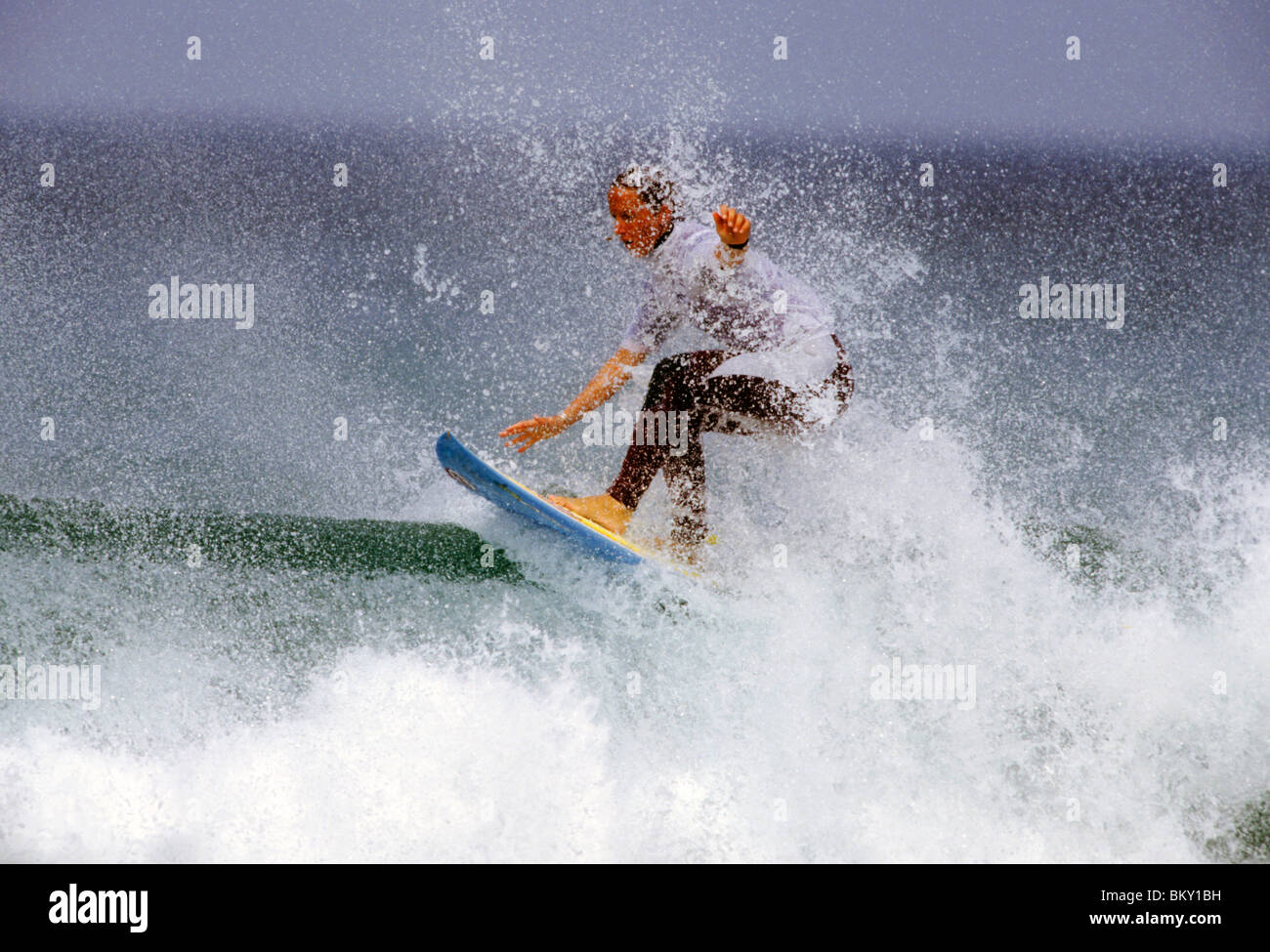 Man surfing wave through surf Stock Photo - Alamy