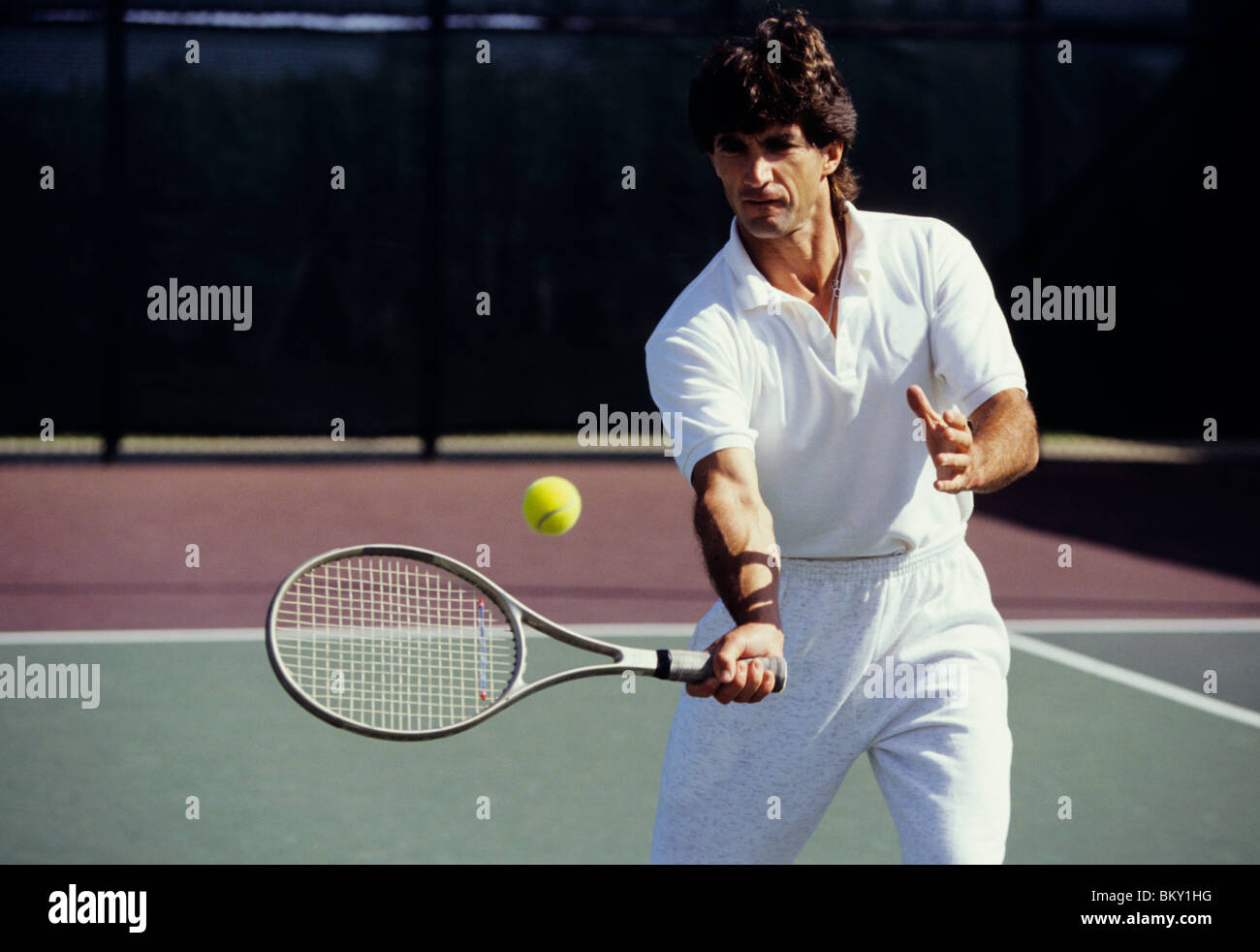 Man returning drop shot during tennis match Stock Photo - Alamy