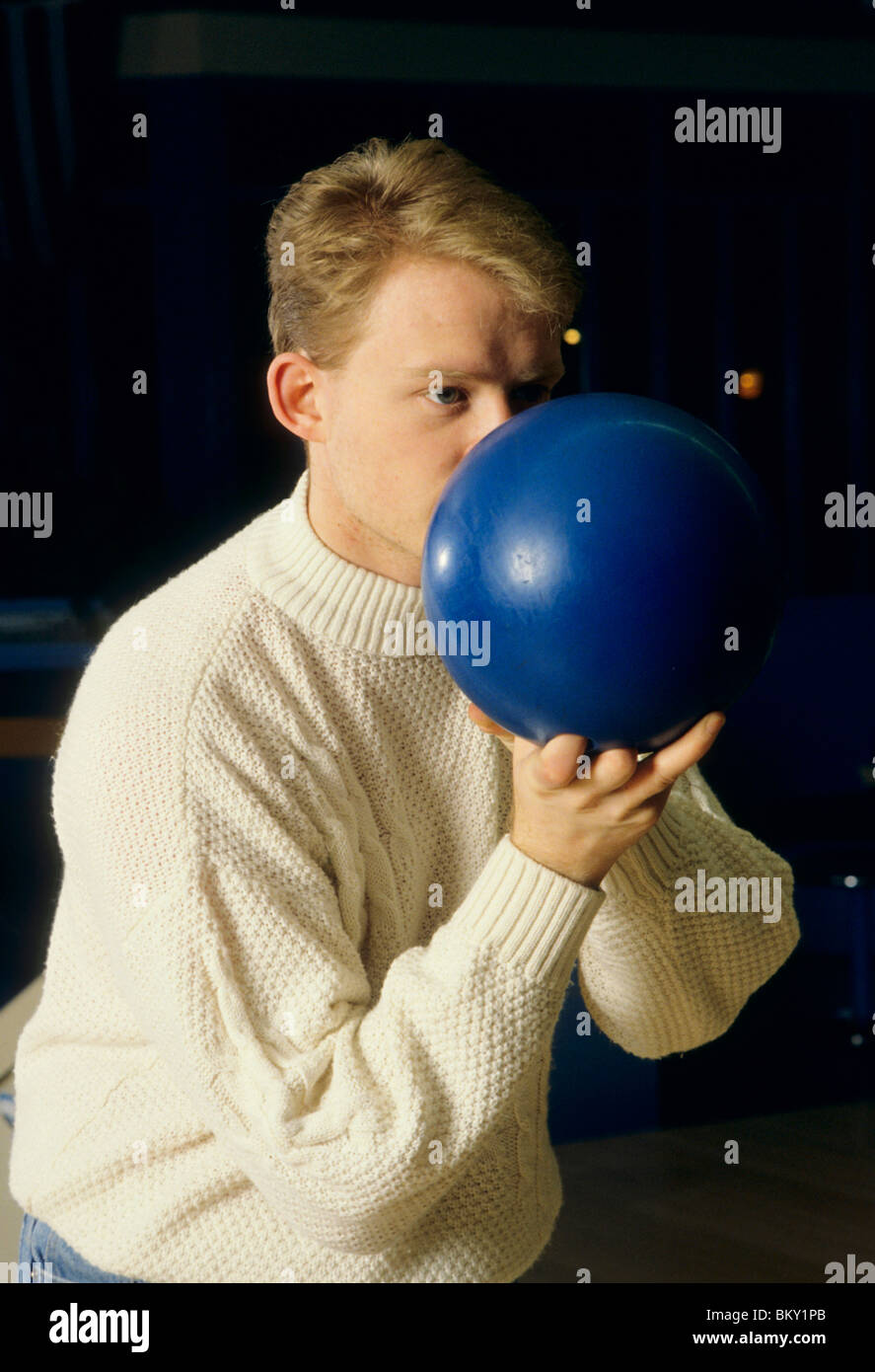 Man with bowling ball ready to bowl down lane Stock Photo - Alamy