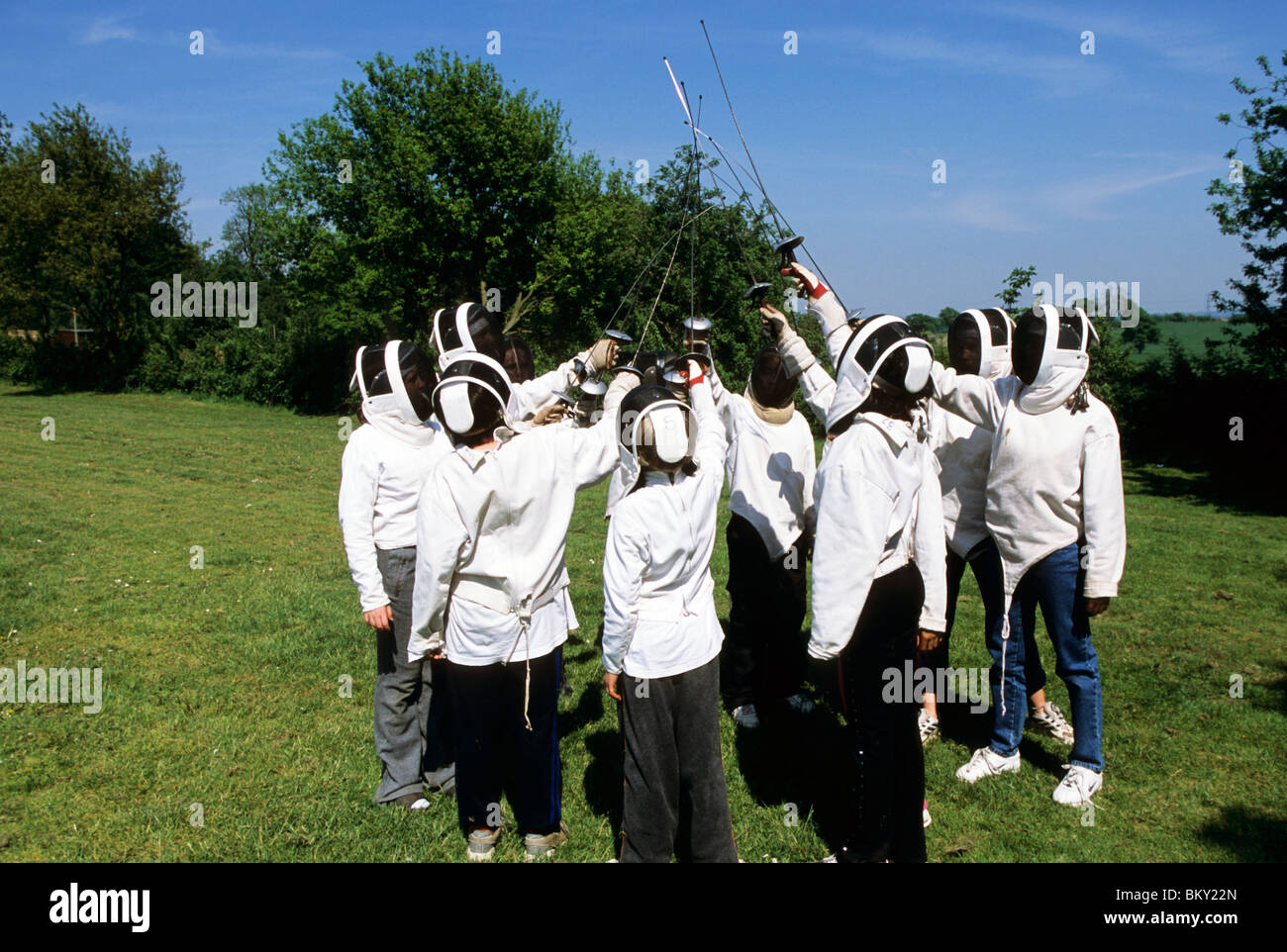 Fencing team with their swords in the air Stock Photo - Alamy