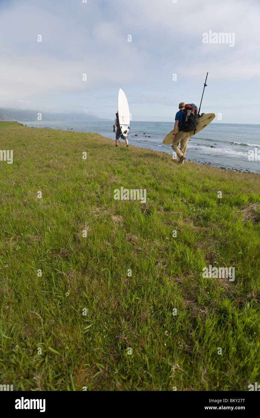 Two men hike with surfboards on The Lost Coast, California Stock Photo ...