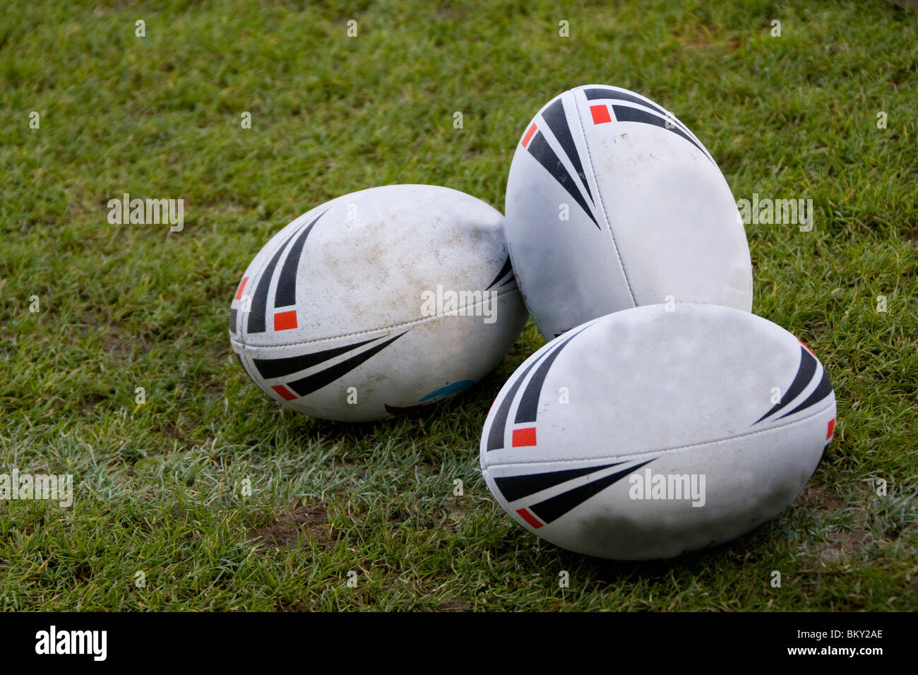 Three Rugby balls shown on pitch Stock Photo - Alamy