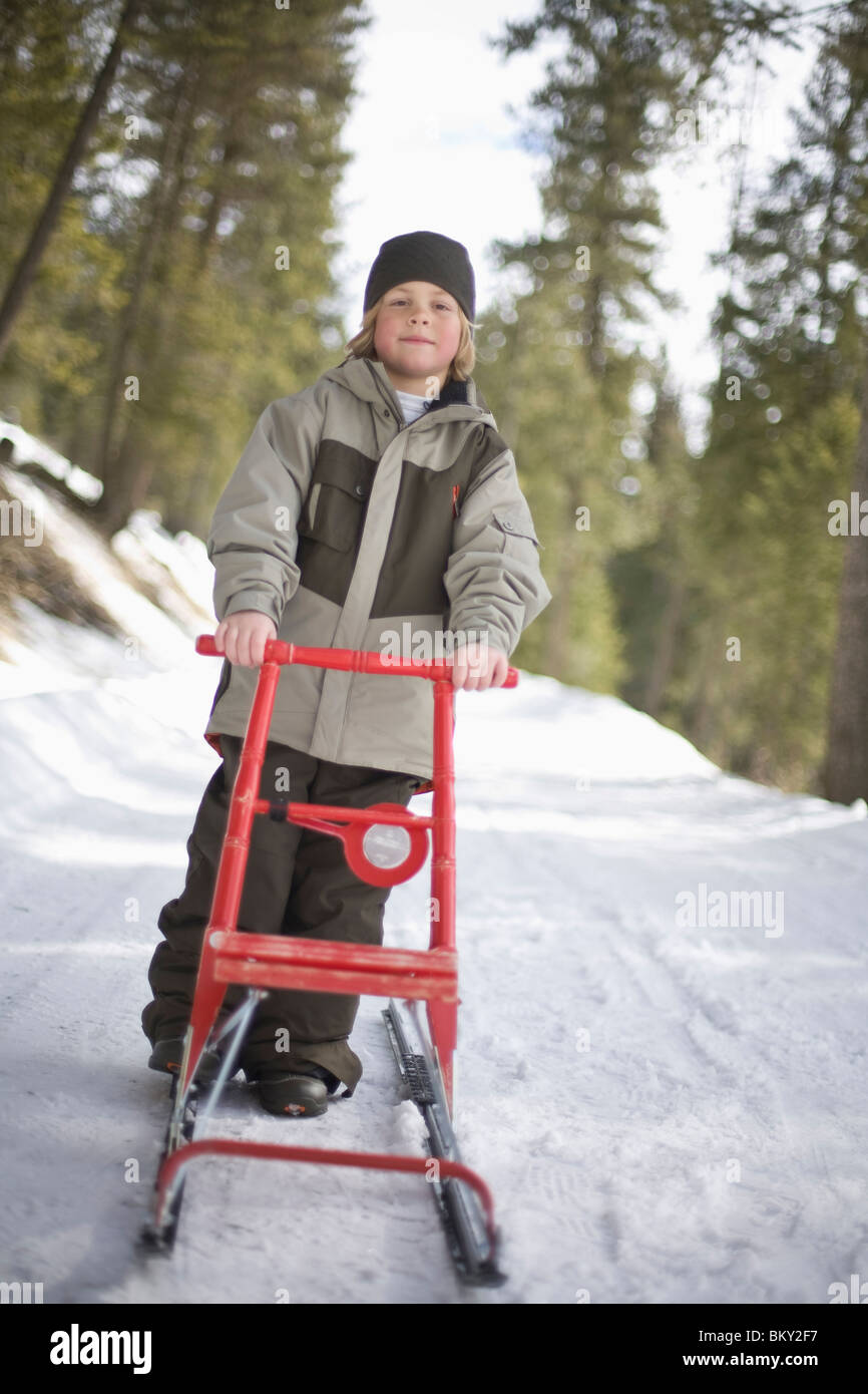 Boy pushing sled hi-res stock photography and images - Alamy