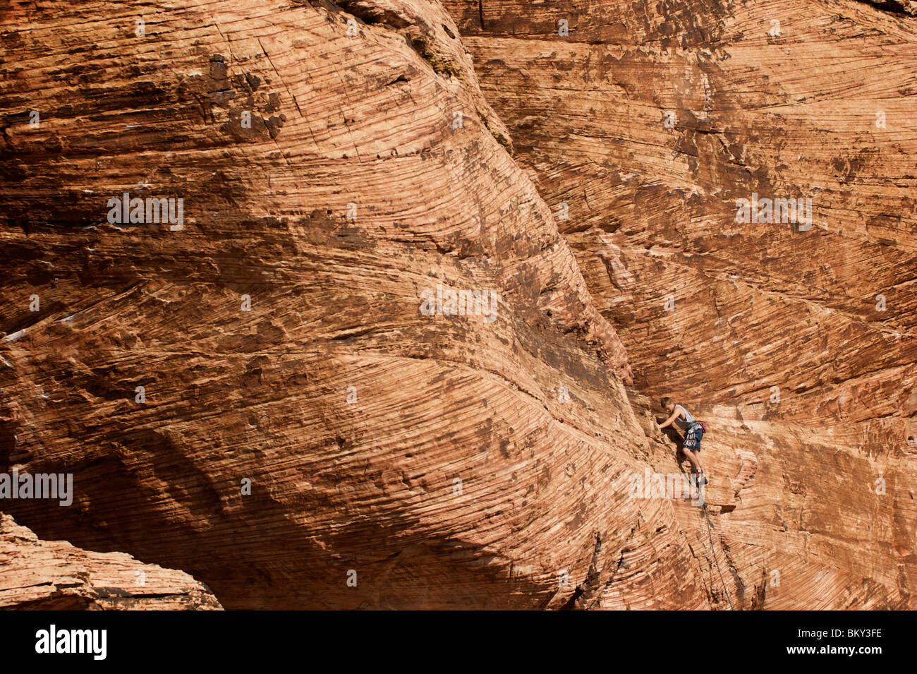 A rock climber ascends a red rock face in Nevada Stock Photo - Alamy