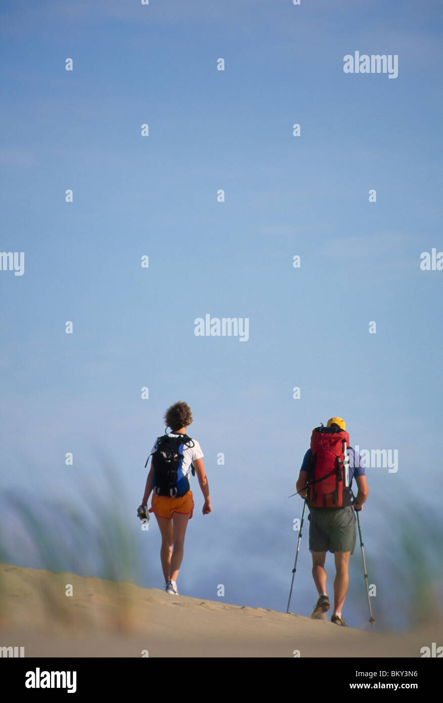 Couple backpacking or fastpacking on dunes along the Oregon coast Stock ...