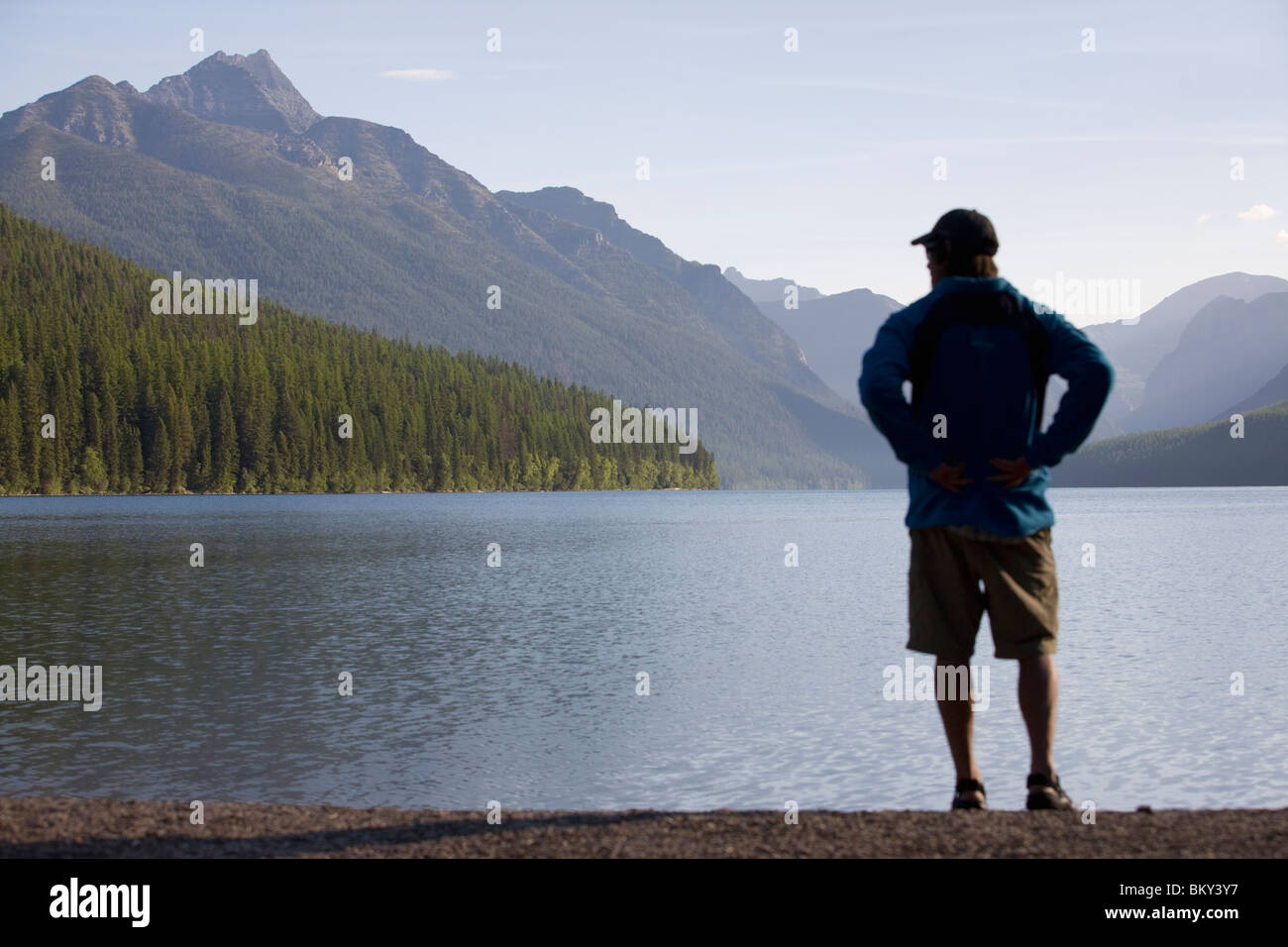 Man looking over a remote lake and mountains deep in Glacier National ...