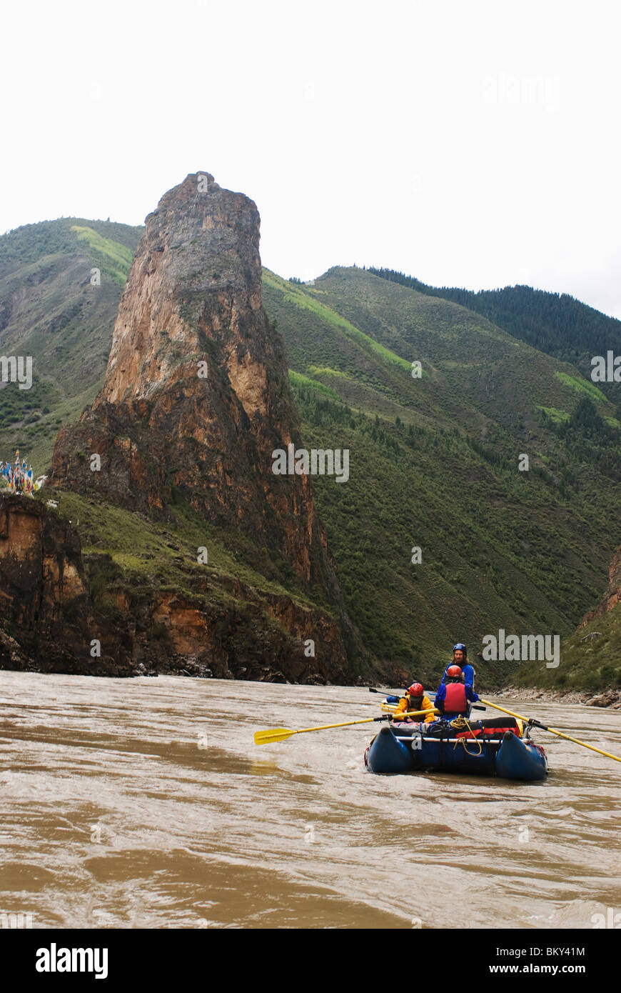 A rubber raft rows downstream during a whitewater rafting trip to ...