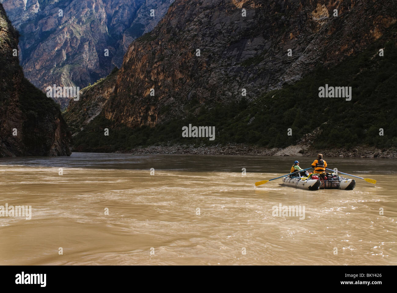 A rubber raft rows downstream during a whitewater rafting trip to ...