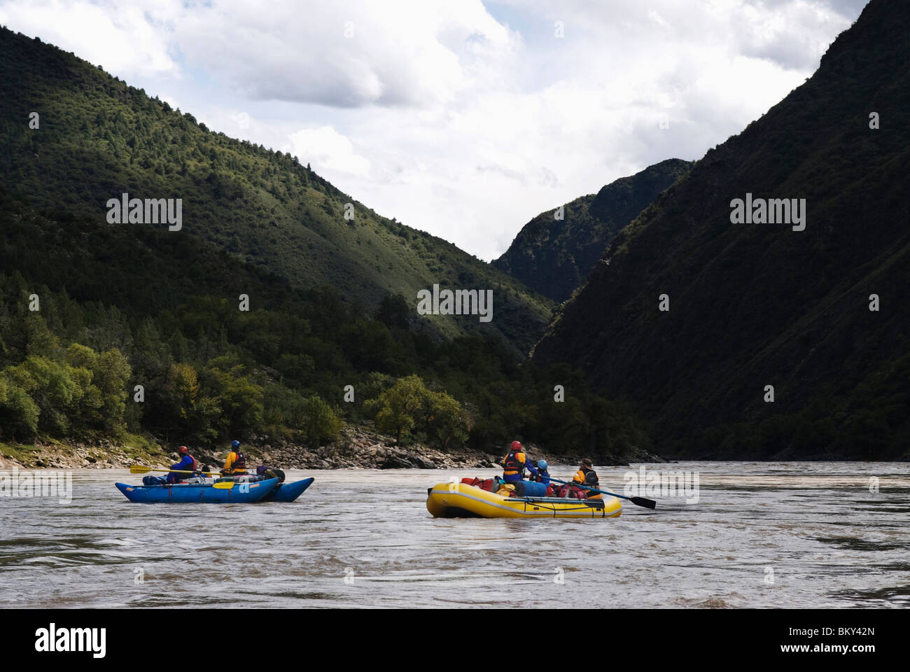 Rubber rafts row downstream during a whitewater rafting trip to Western ...