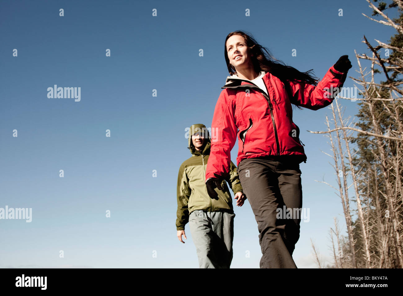 A couple walking along a large drift log at Rialto Beach Stock Photo ...