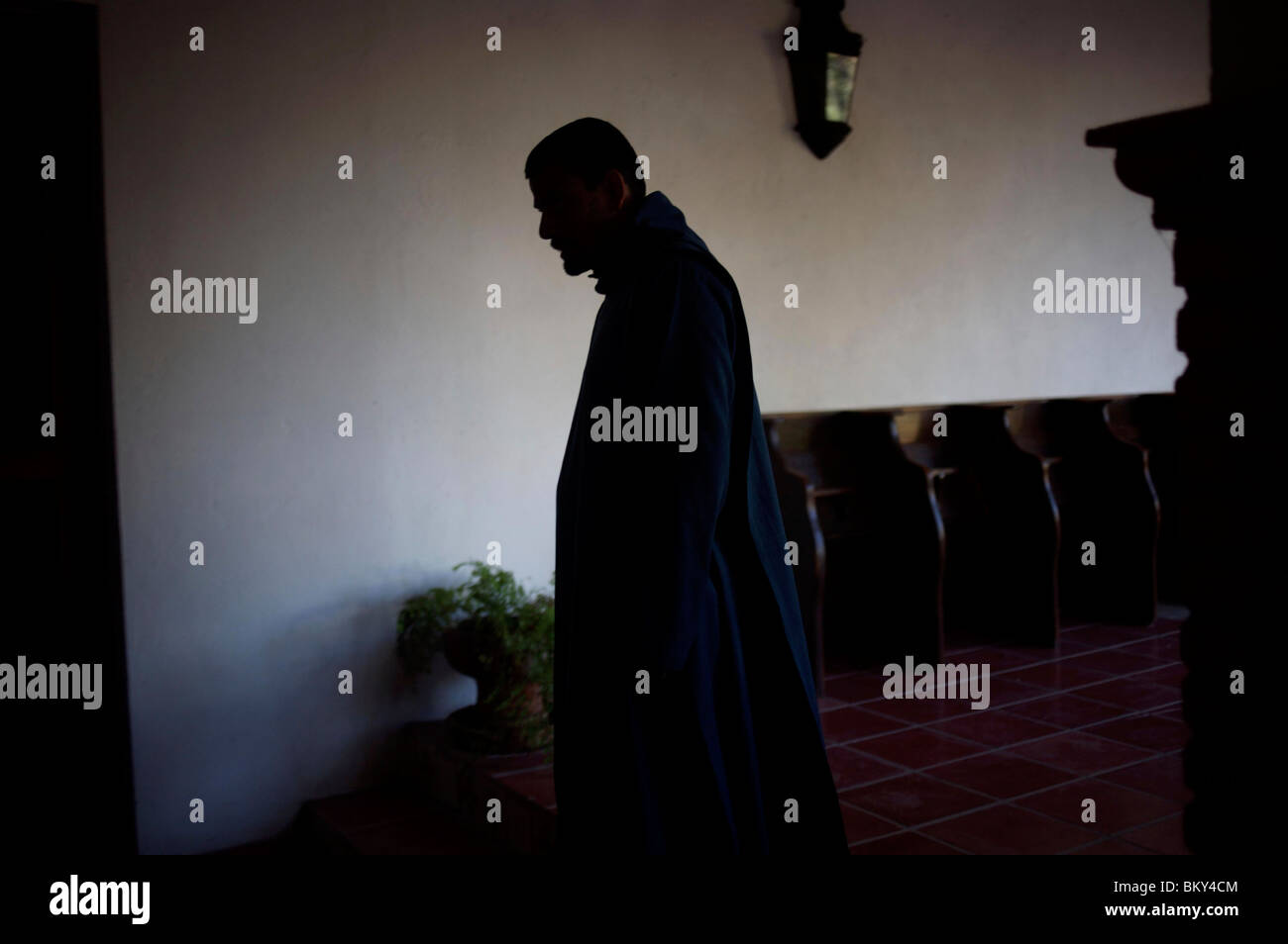 A Benedictine monk walks in the cloister of the Our Lady of Solitude ...