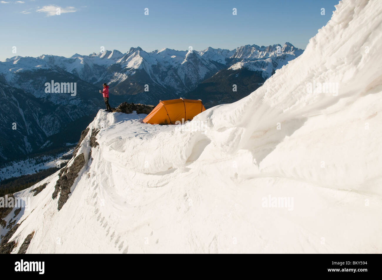 A woman camping on a snowy ridge above Molas Pass, San Juan National ...