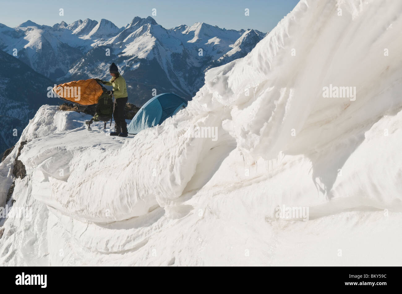 A woman camping on a snowy ridge above Molas Pass, San Juan National ...