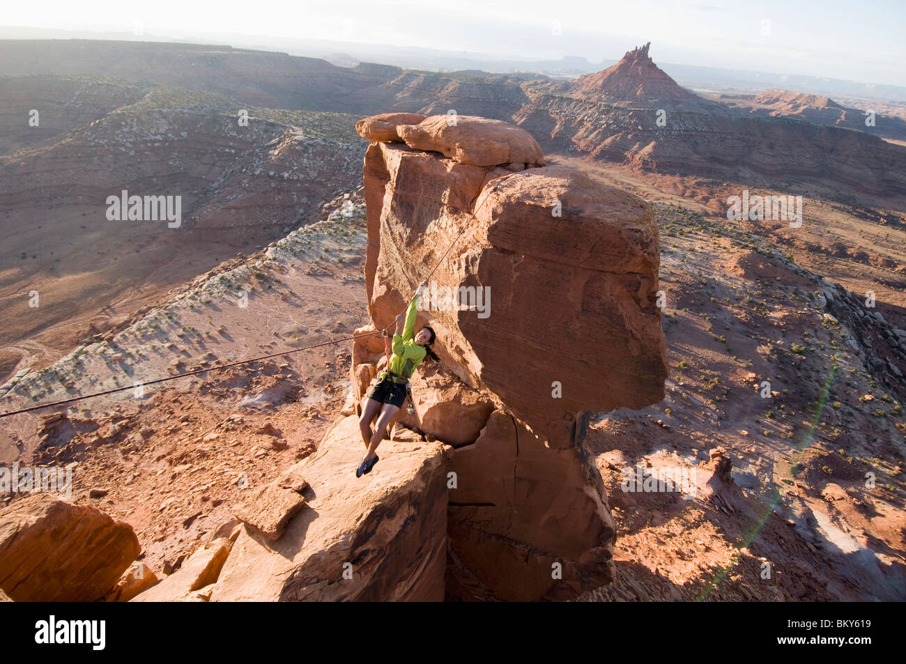A woman completing a tyrolean traverse on the South Six Shooter Towers ...