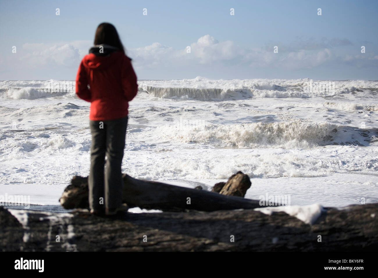 A woman watching ocean waves in a turbulent sea Stock Photo - Alamy