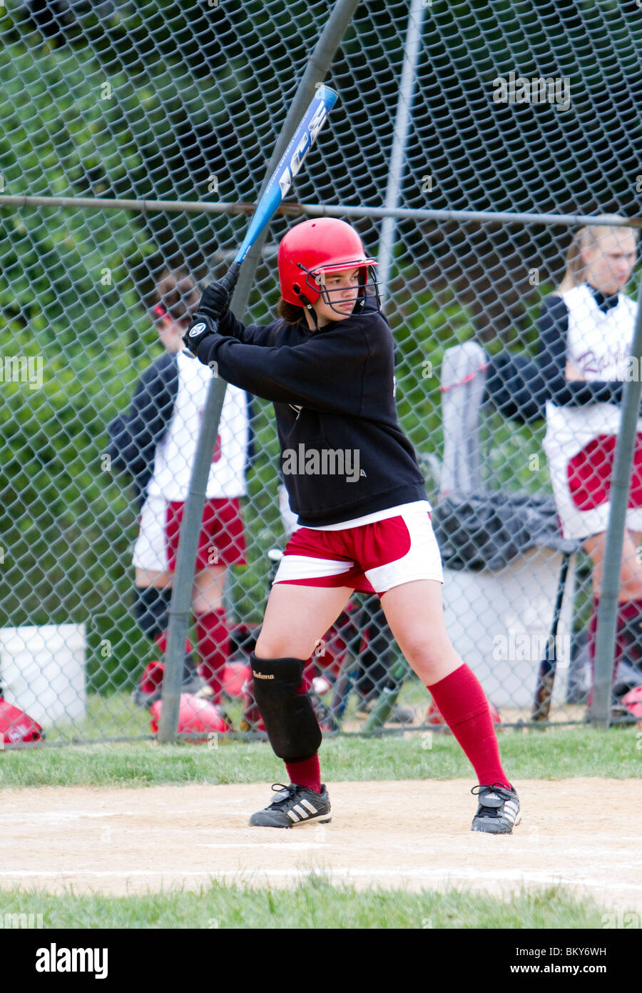 A high school girls softball game. A batter at bat at home plate Stock ...