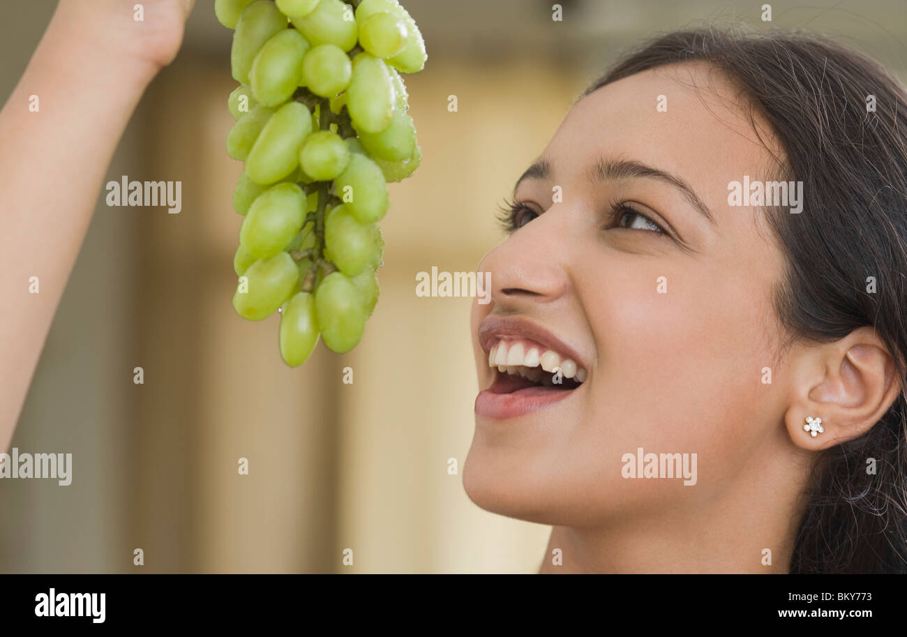 Woman eating grapes Stock Photo - Alamy