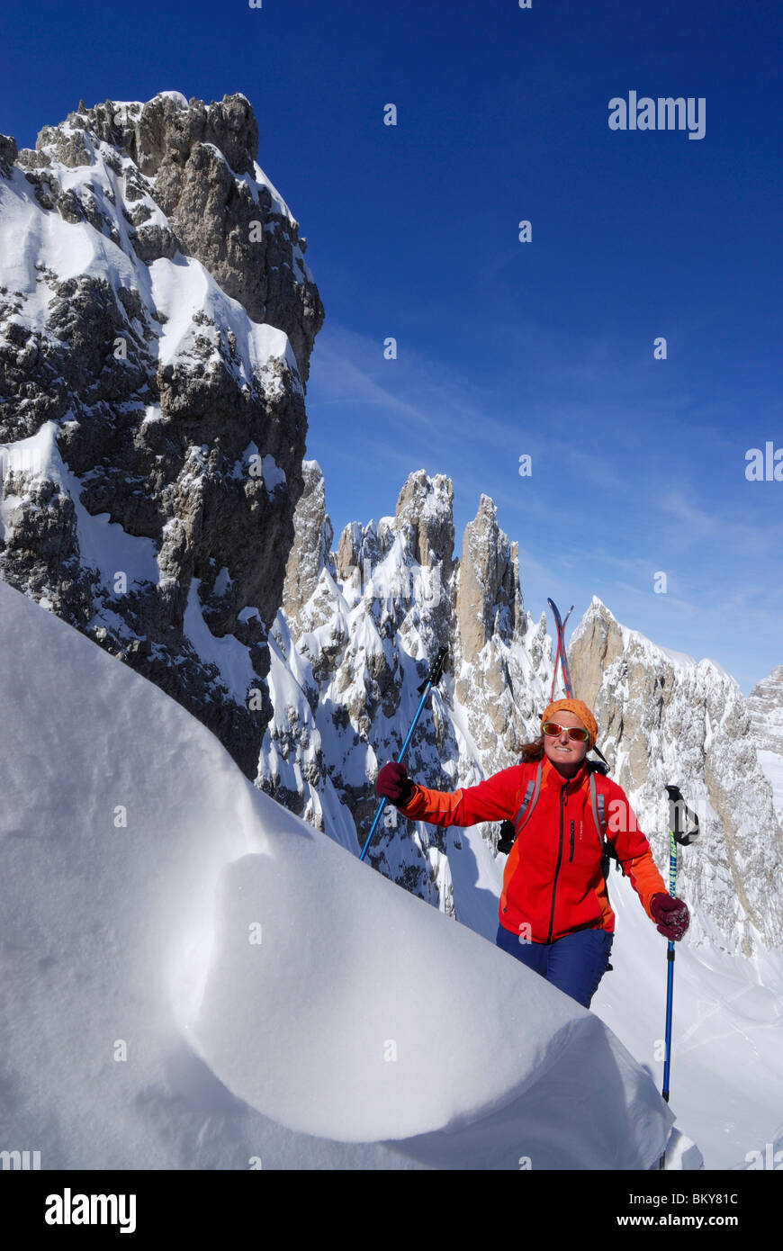 Female backcountry skier ascending, Cadini range, Dolomites, Trentino ...
