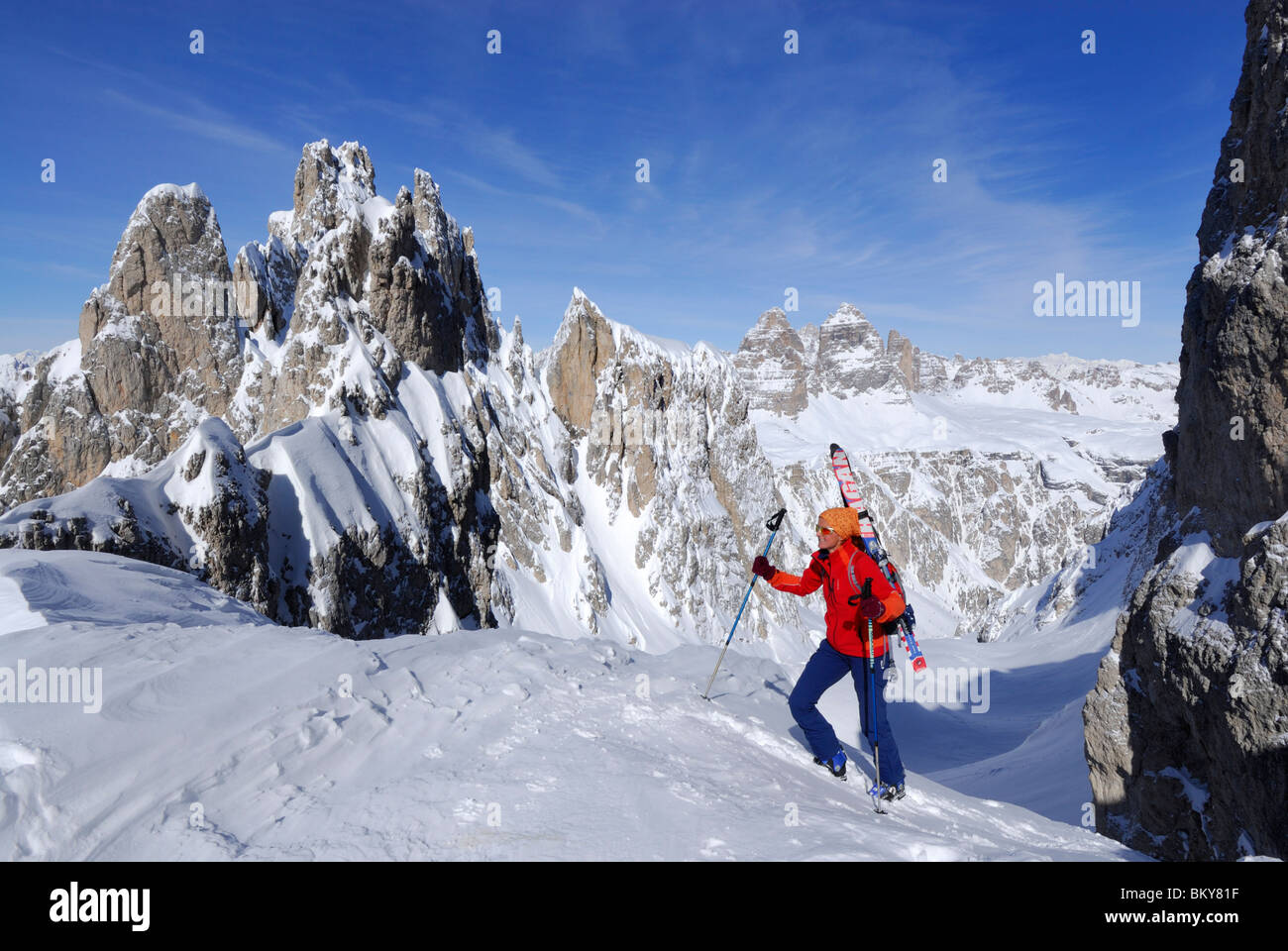 Female backcountry skier ascending, Cadini range, Dolomites, Trentino ...