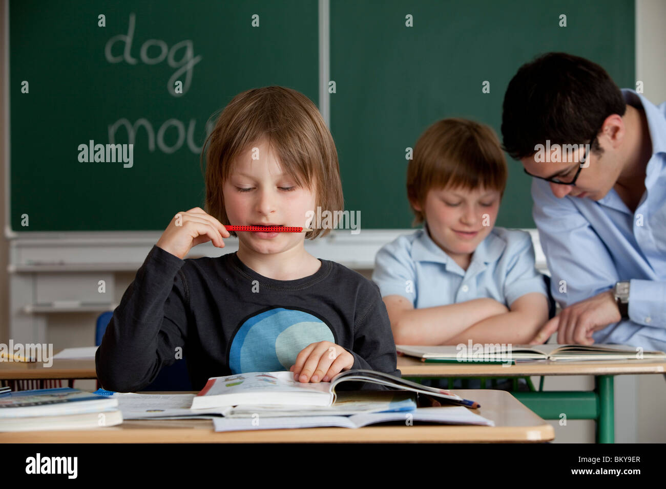 Schoolboys and male teacher in classroom, Hamburg, Germany Stock Photo ...