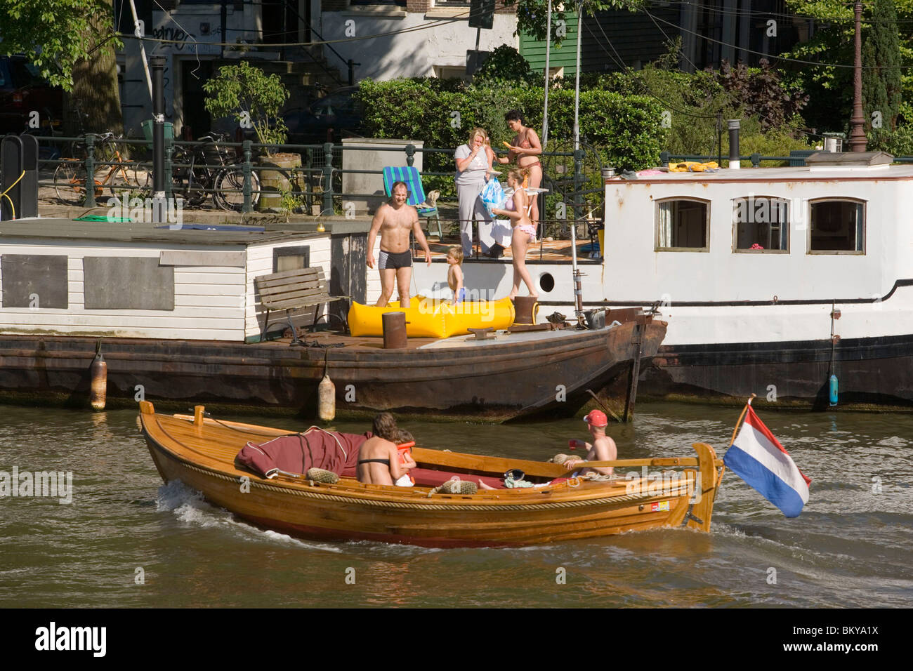 Leisure Boats, Oude Schans, A small leisure boat passing house boats on ...