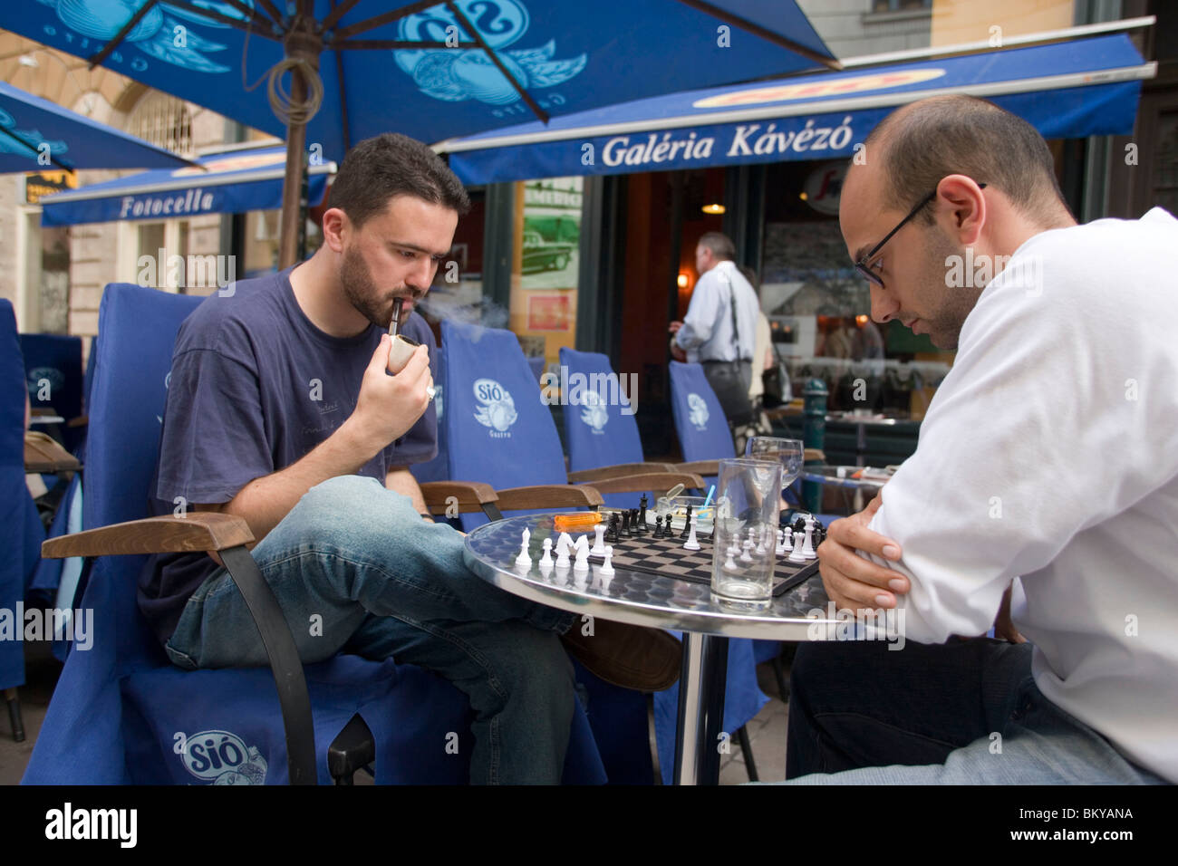 Two men playing chess, Two men playing chess in an open-air restaurant ...