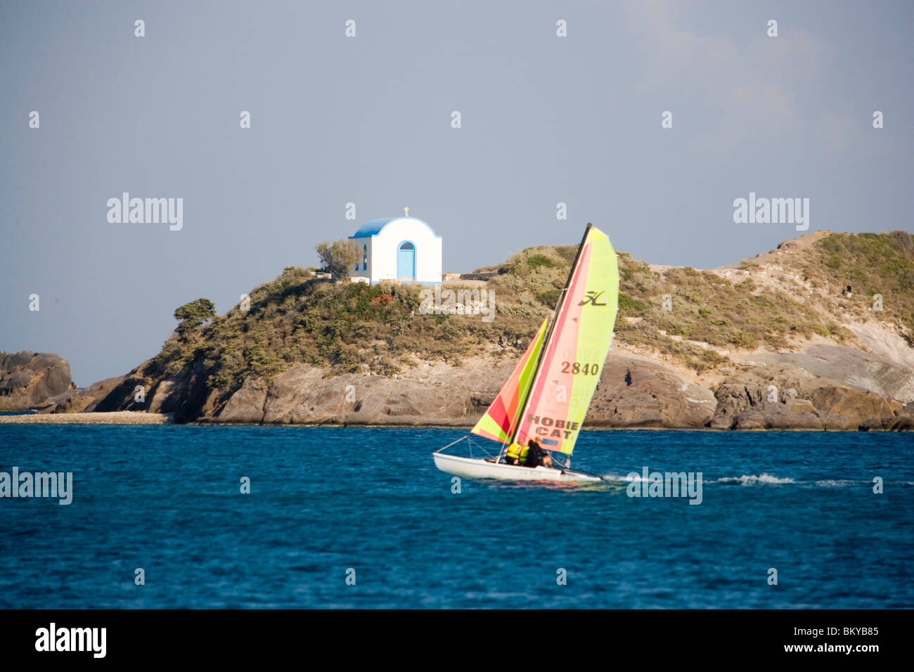 Catamaran passing Kastri island with capel St. Nicholas, Kefalos, Kos ...