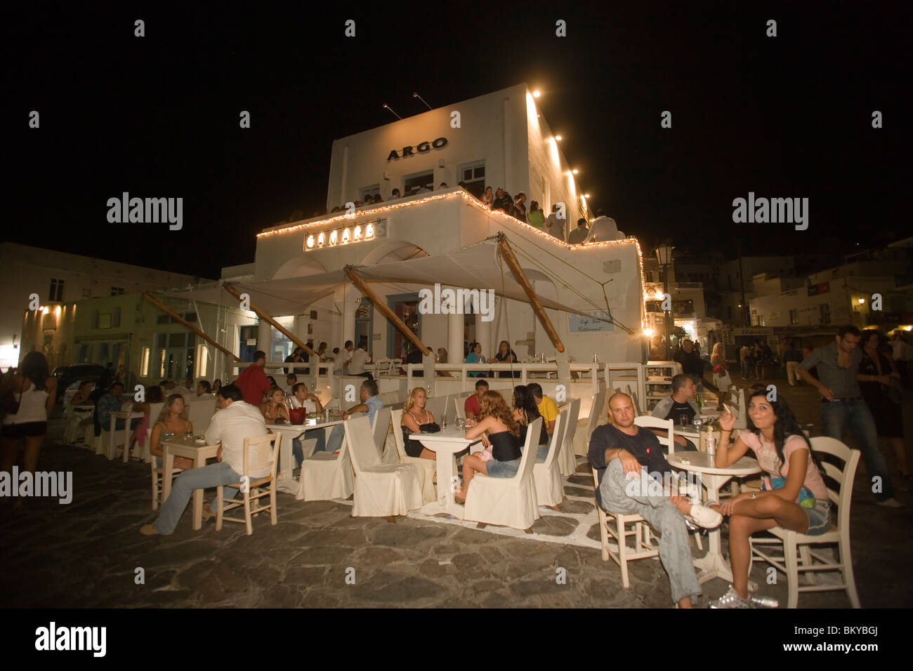 People sitting in open-air area of Argo Bar near harbour, Mykonos-Town ...
