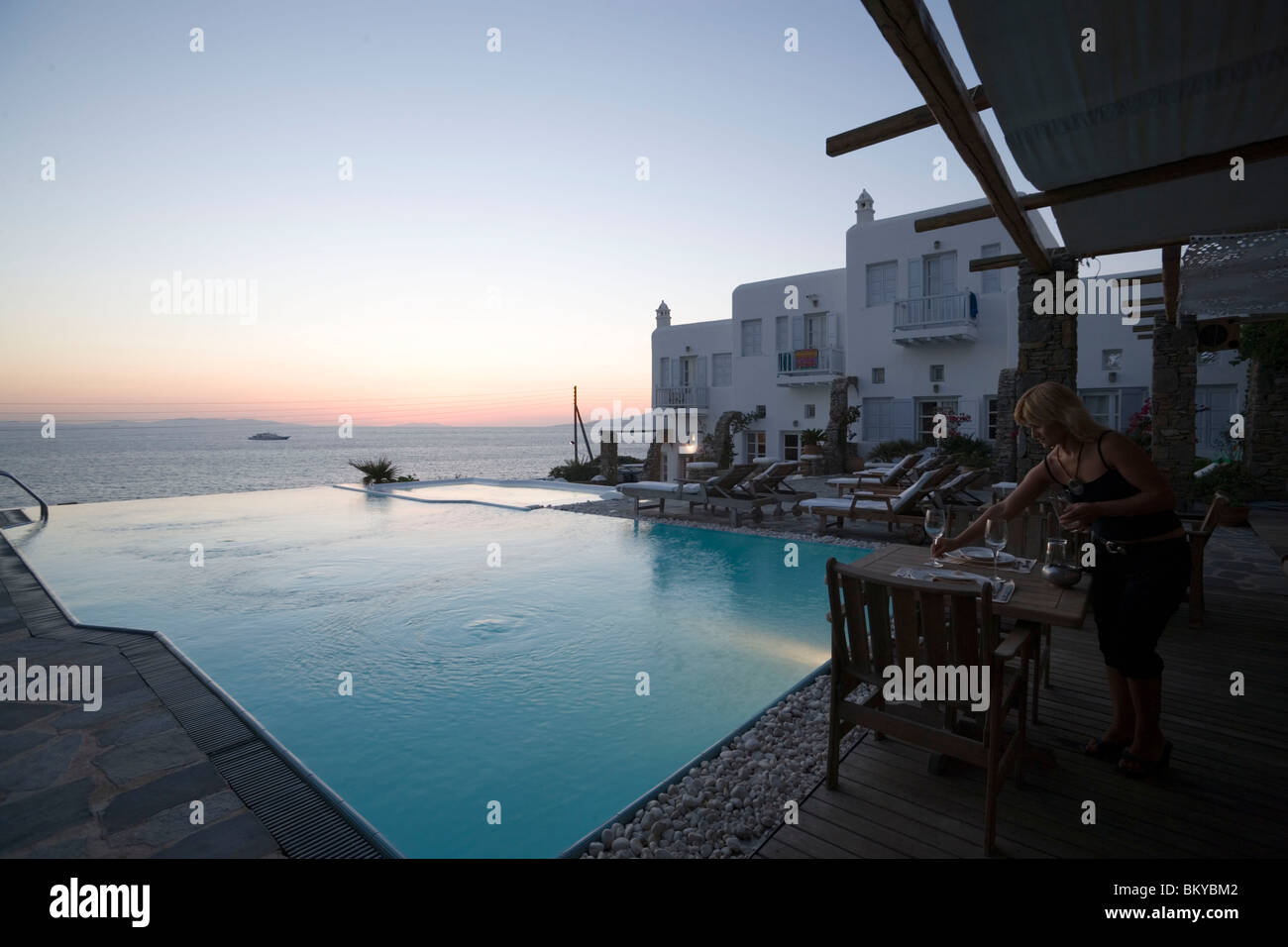 Waitress setting the table near the fresh water pool of the Apanema ...