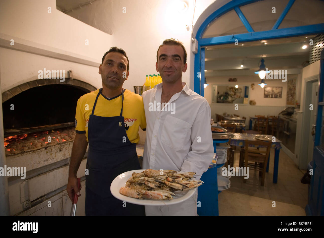 Cook and waiter of the greek fish restaurant Kounelas, Mykonos-Town ...