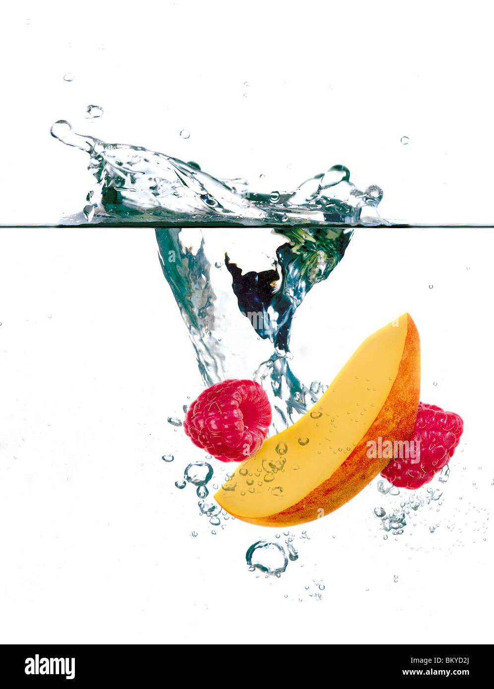 Peach slice and raspberry falling into water Stock Photo - Alamy