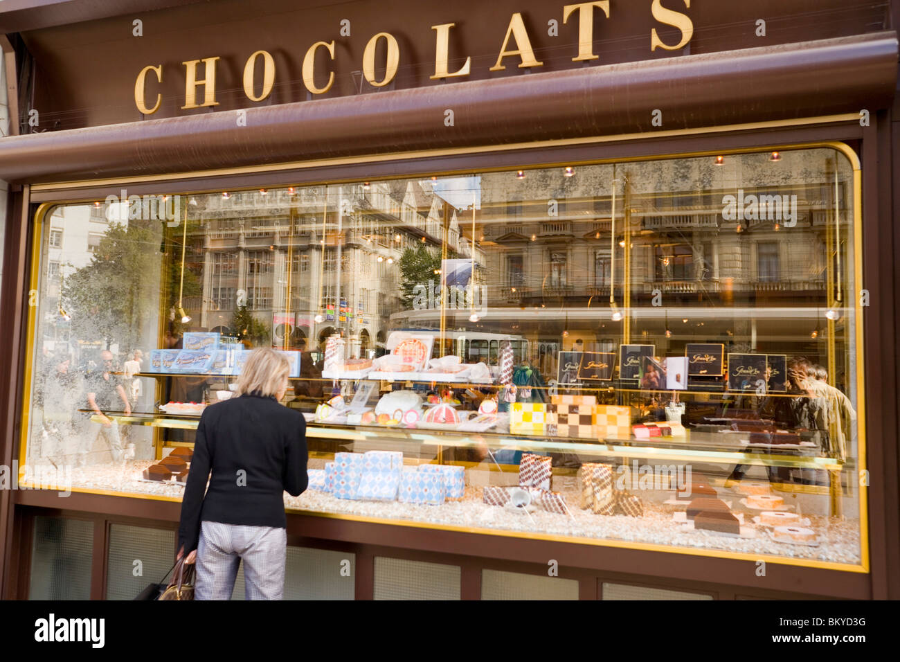 Woman standing at shop window of Spruengli (famous chocolate ...