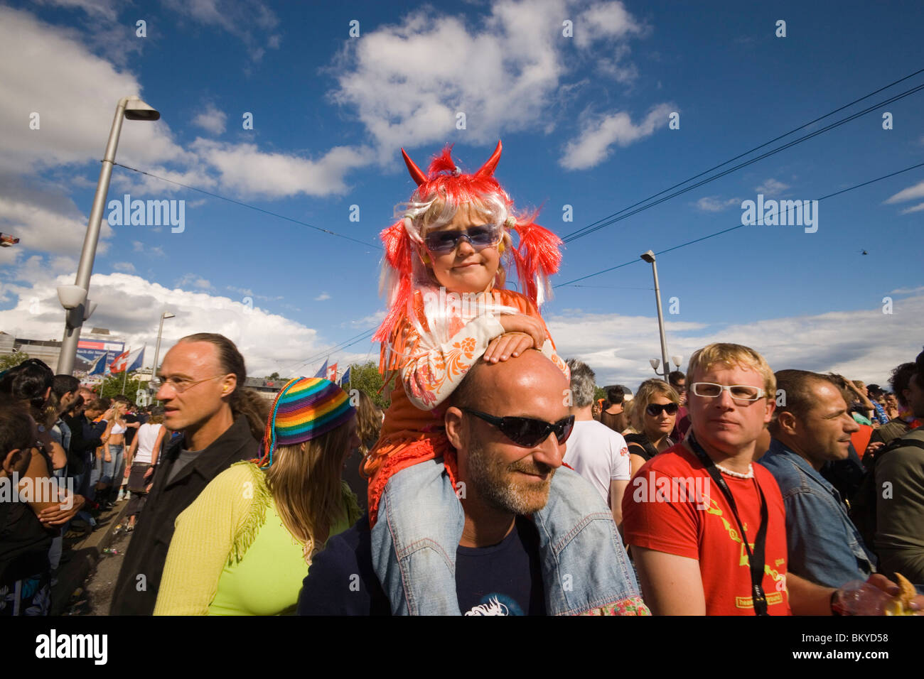 Flashy dressed up girl sitting on father's shoulder, Street Parade (the ...