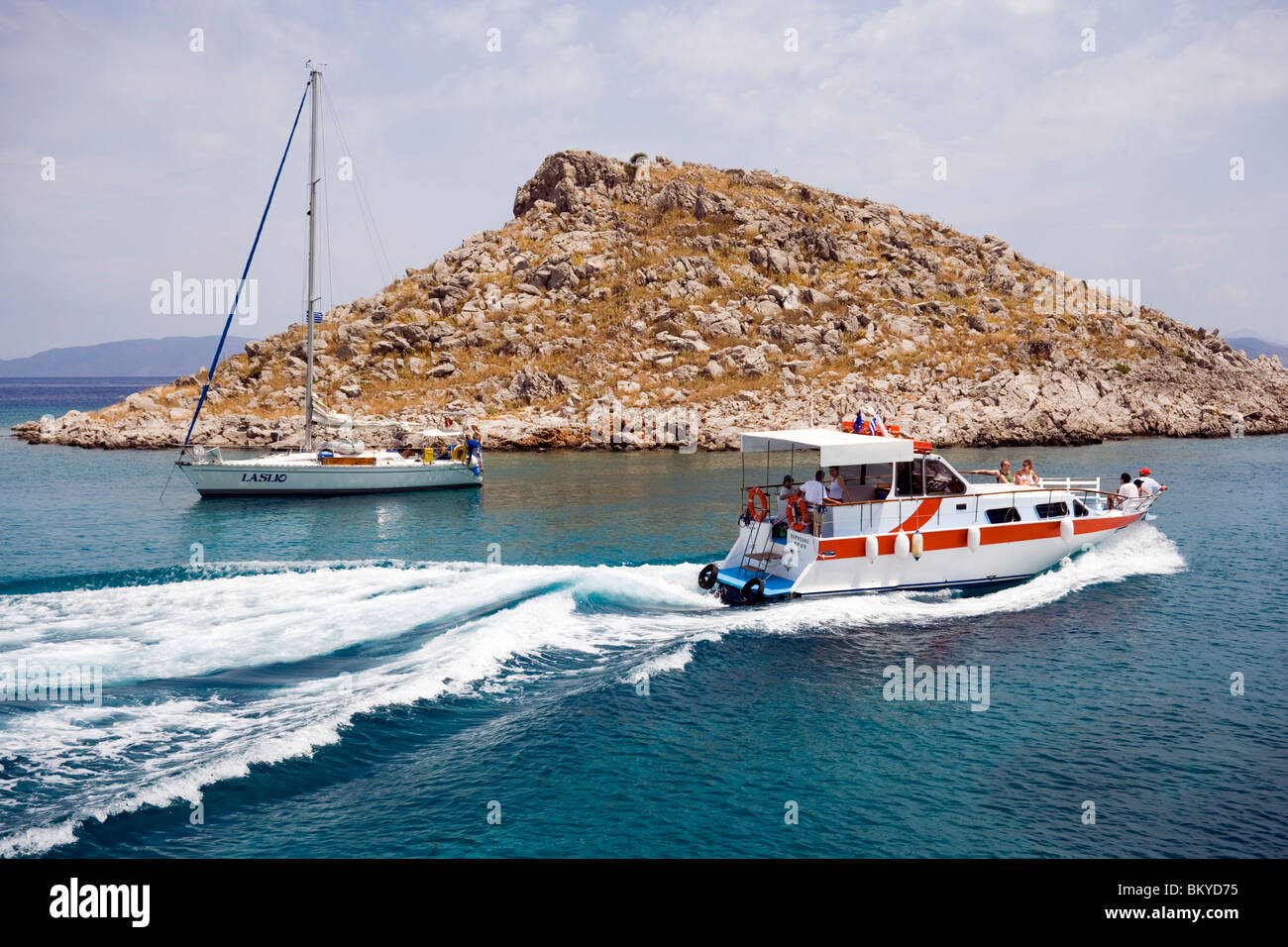 Taxi boat and sailing boat in bay near Agia Marina Beach, Pedi, Symi ...
