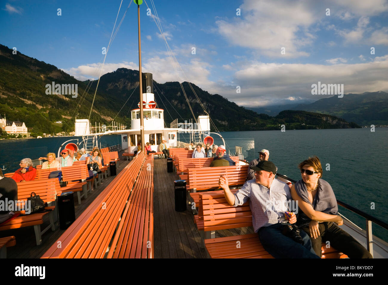 Passengers sitting on deck of a paddle wheel steamer, Lake Lucerne ...