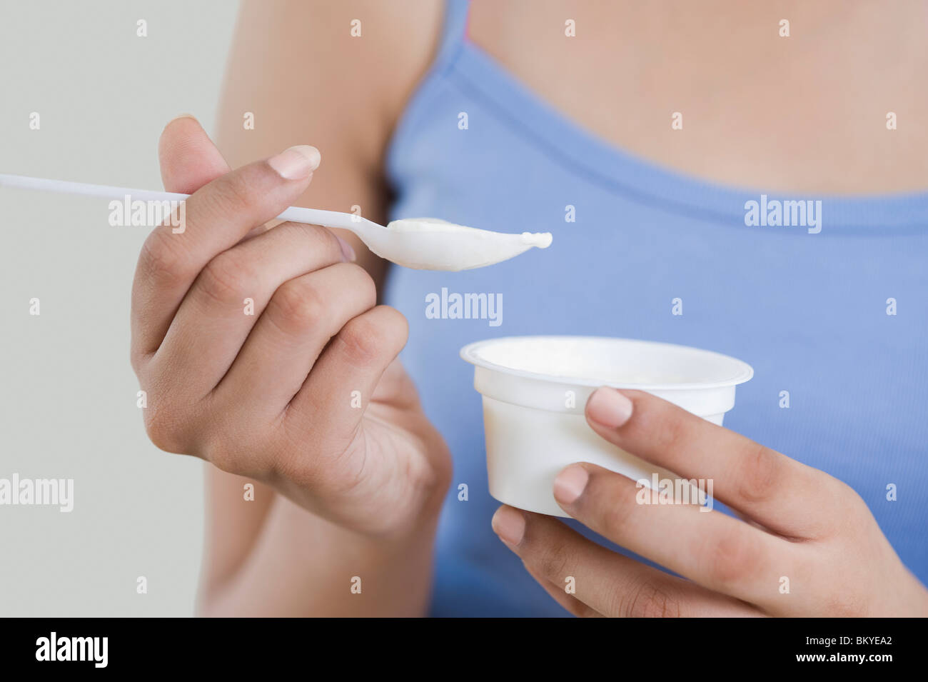 Mid section view of a woman eating ice cream Stock Photo - Alamy