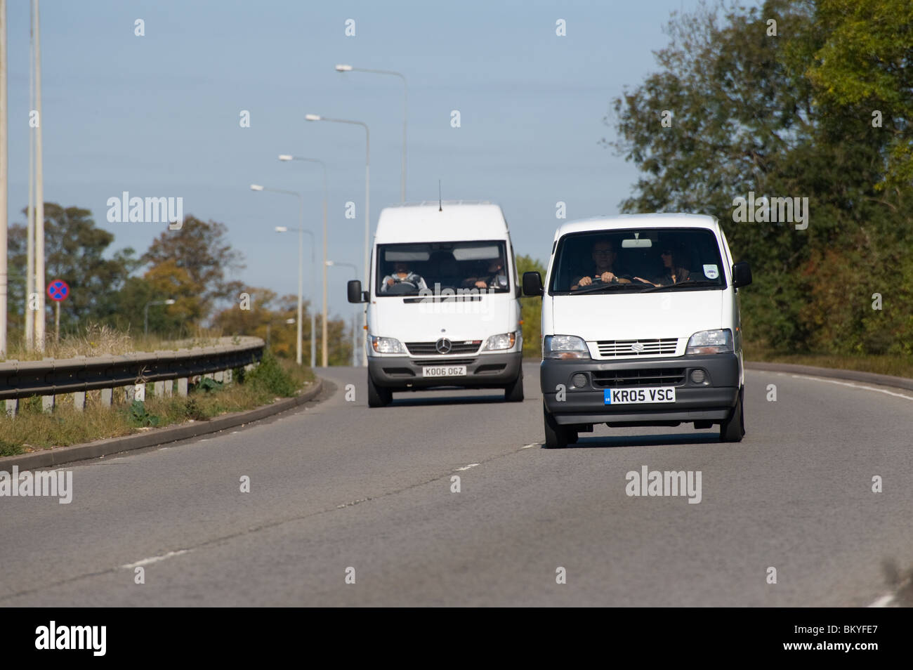 White vans being driven on a dual carriageway in England Stock Photo ...