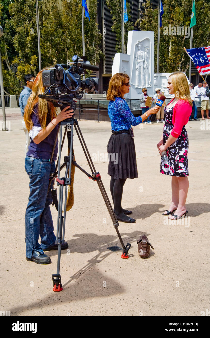 A television news reporter interviews a protester at a "Tea Party ...