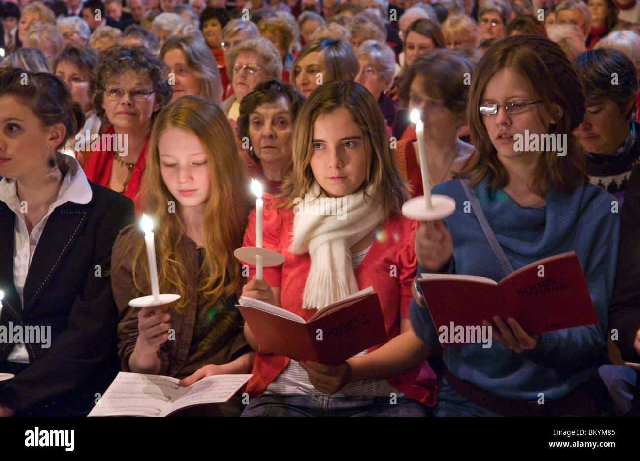 Congregation singing and holding candles during filming of BBC Songs of ...