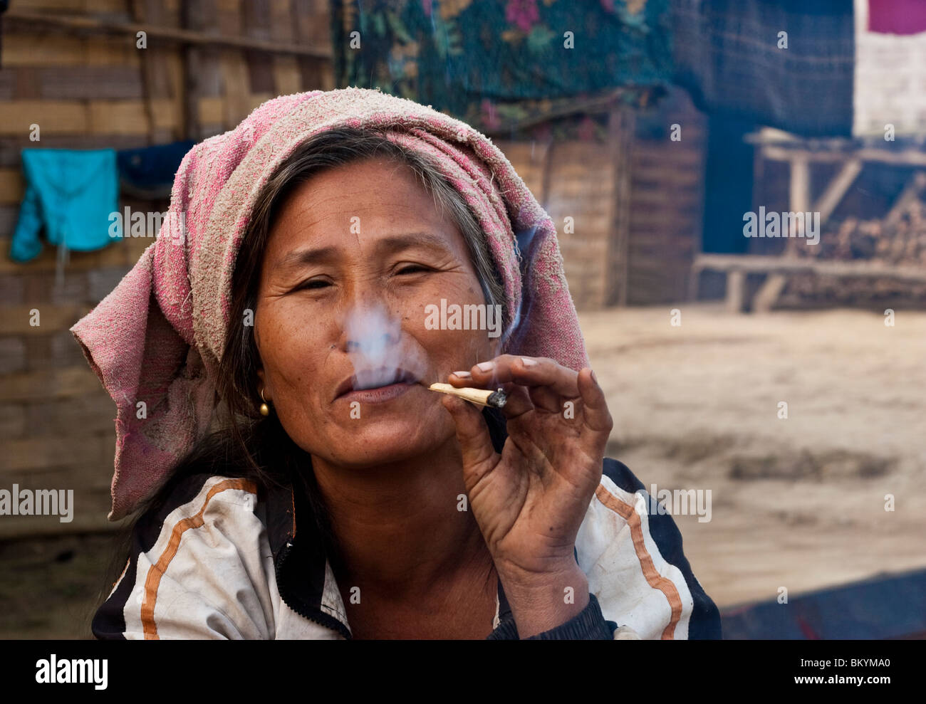 Hill tribe woman smoking cigarette in Luang Prabang, Laos Stock Photo ...