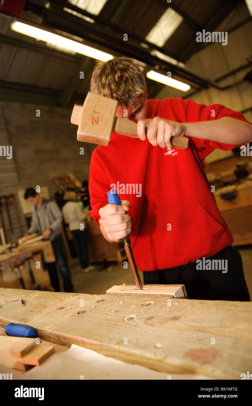 Teenage boy learning woodworking skills at a vocational learning class ...