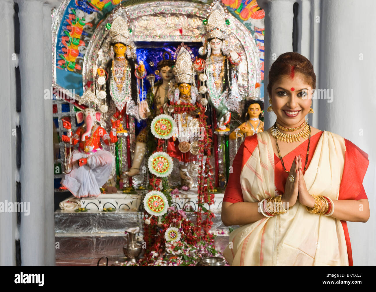 Woman praying in a temple Stock Photo - Alamy