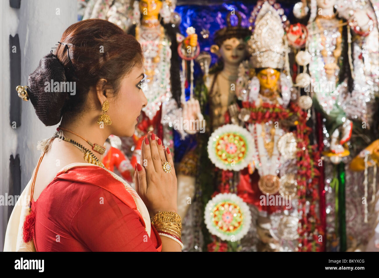 Woman praying in a temple Stock Photo - Alamy