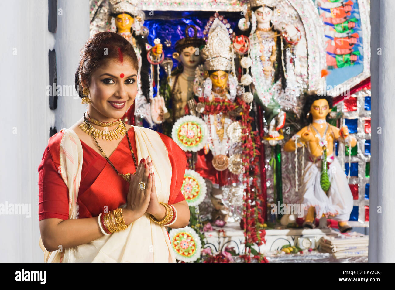 Woman praying in a temple Stock Photo - Alamy