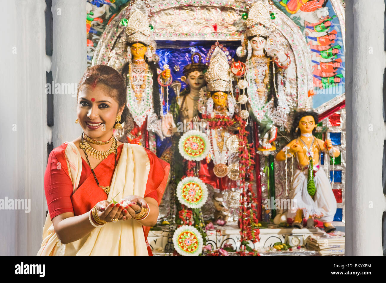 Woman holding offerings in a temple Stock Photo - Alamy