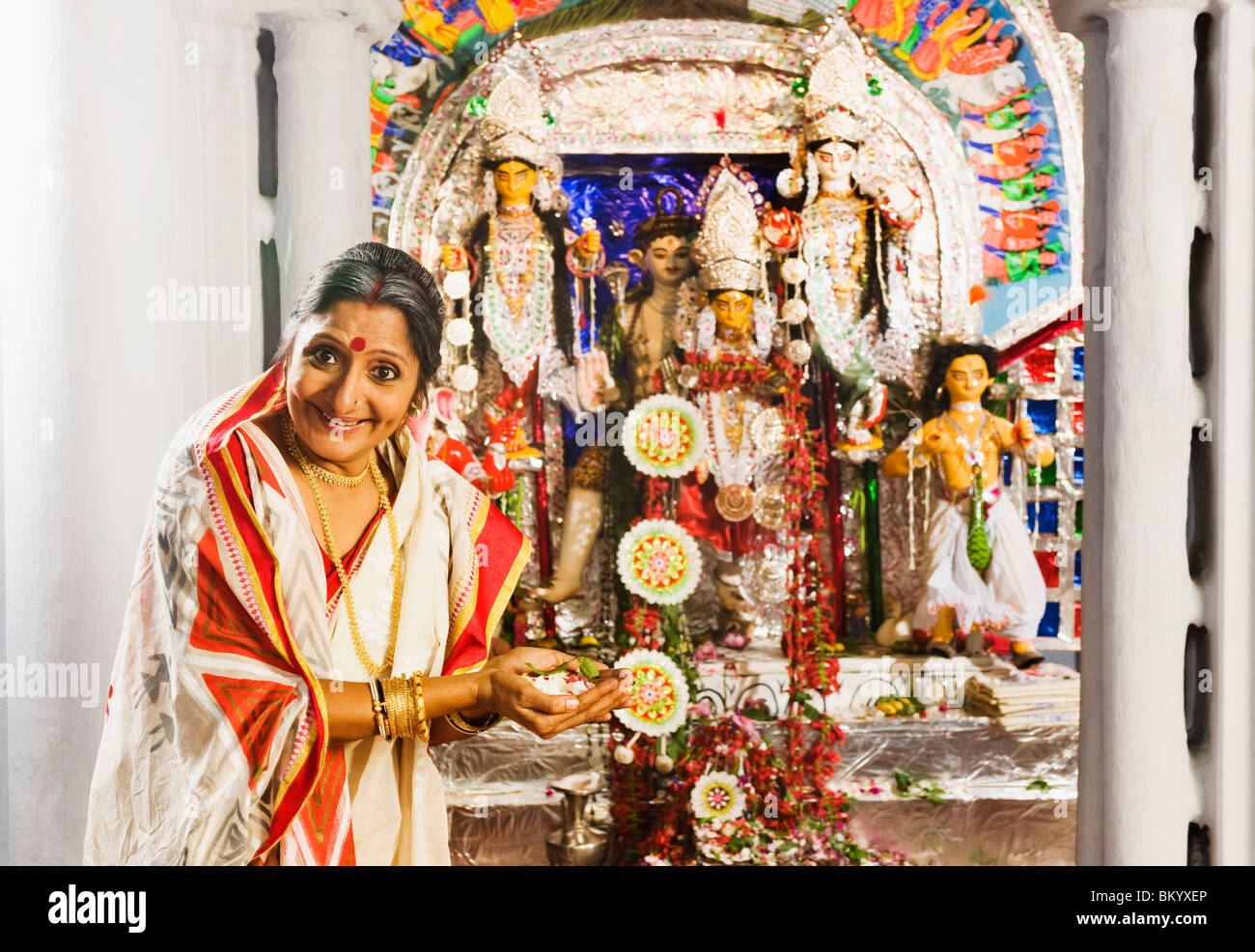 Woman holding offerings in a temple Stock Photo - Alamy