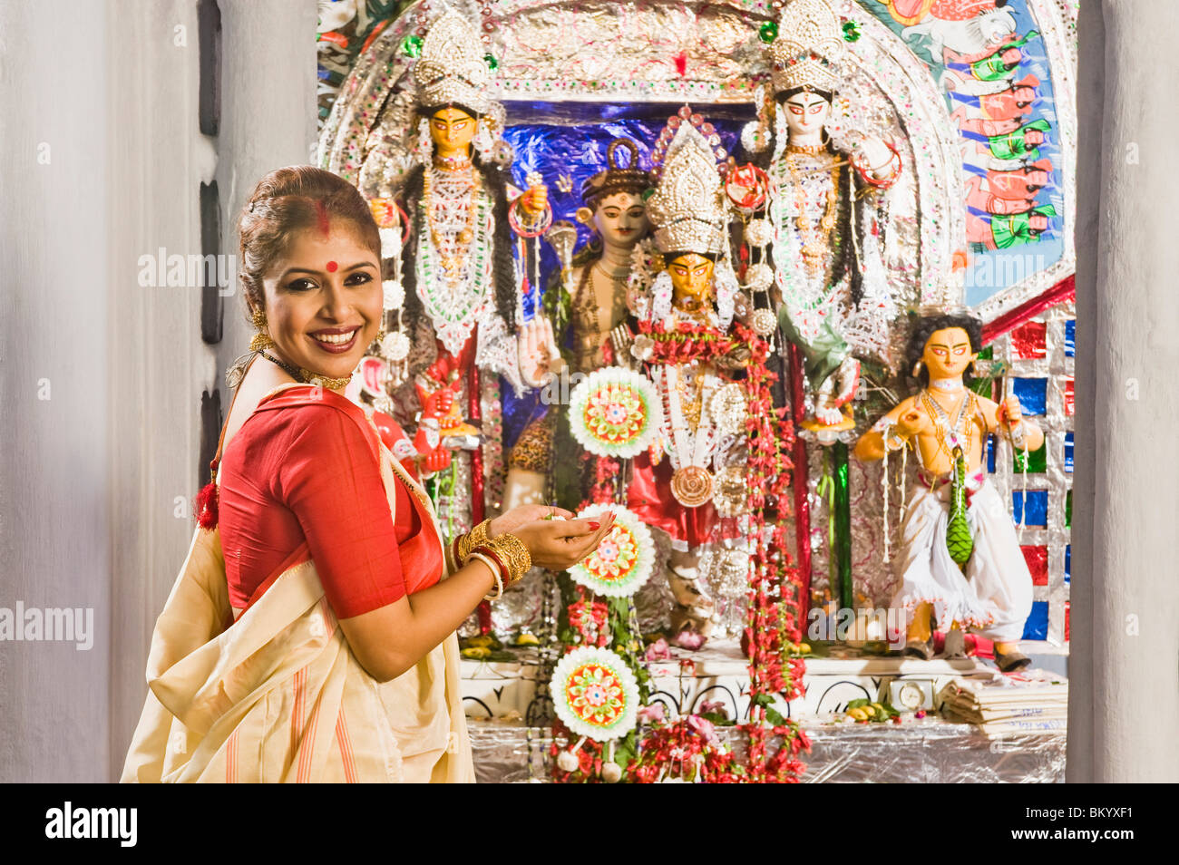 Woman holding offerings in a temple Stock Photo - Alamy