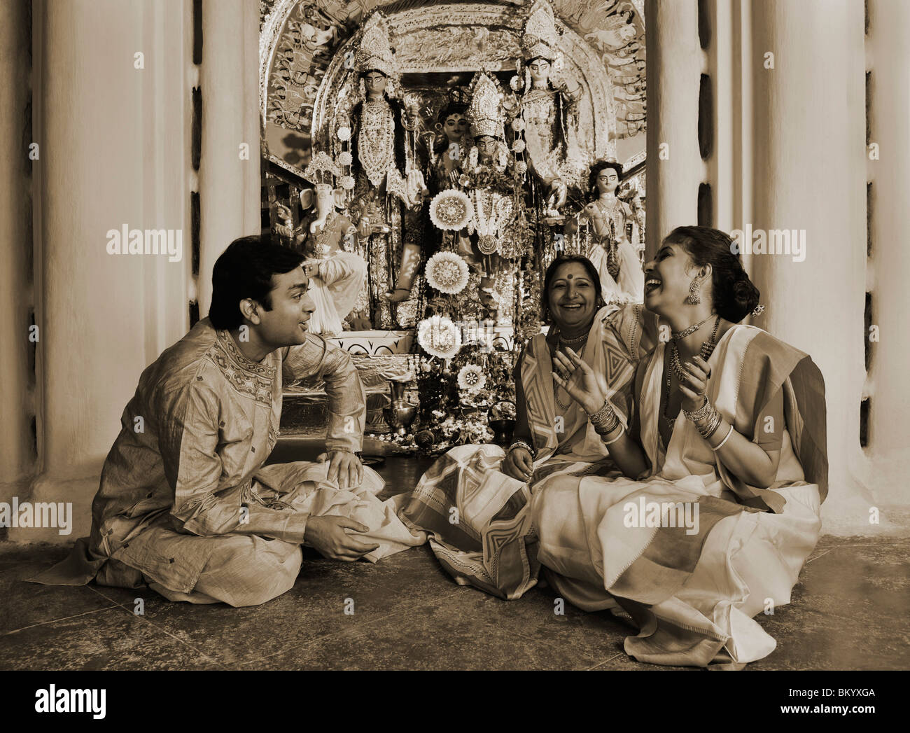 Family sitting in a temple Stock Photo - Alamy