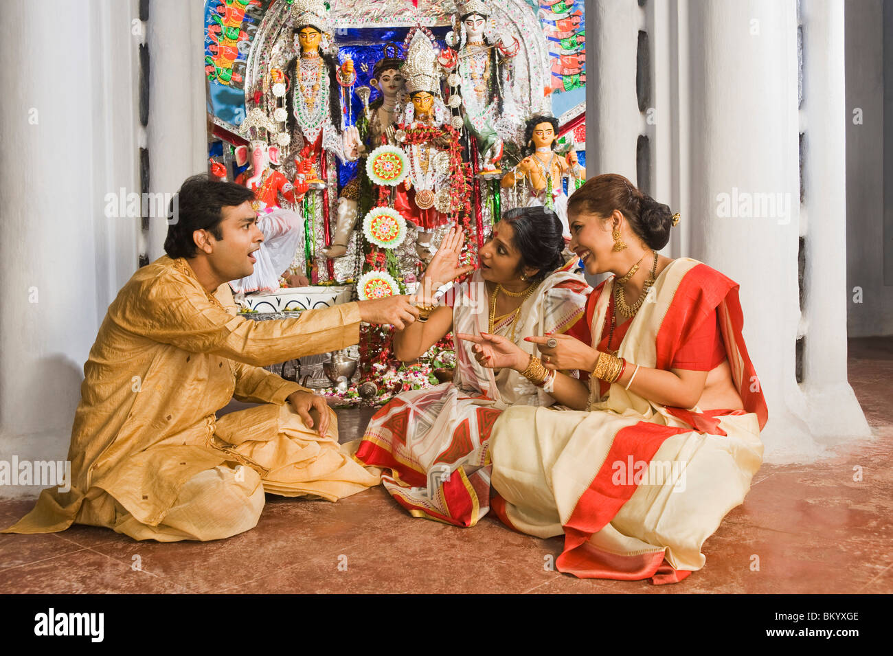 Family sitting in a temple Stock Photo - Alamy