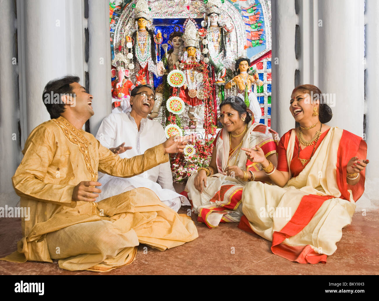Family sitting in a temple Stock Photo - Alamy